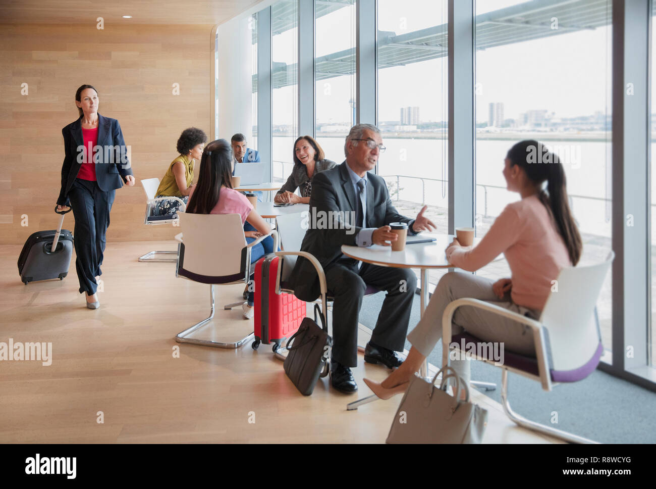 Business people working and talking in airport business lounge Stock ...