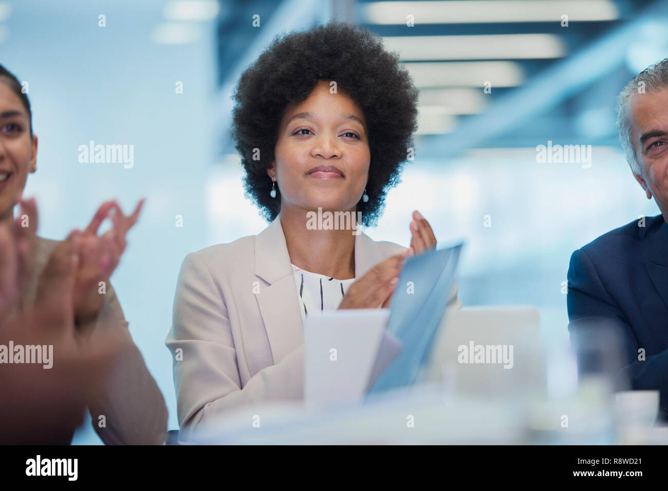 Confident businesswoman clapping in conference room meeting Stock Photo ...