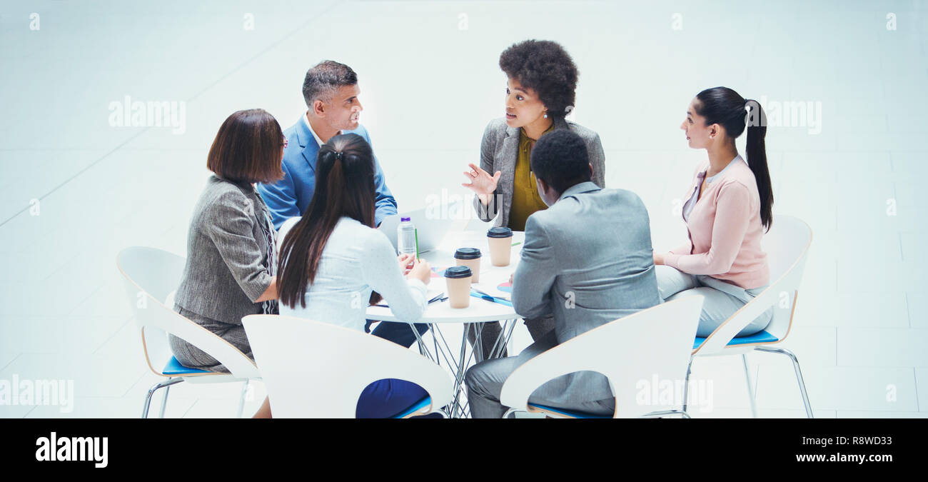 Business people talking at round table Stock Photo - Alamy