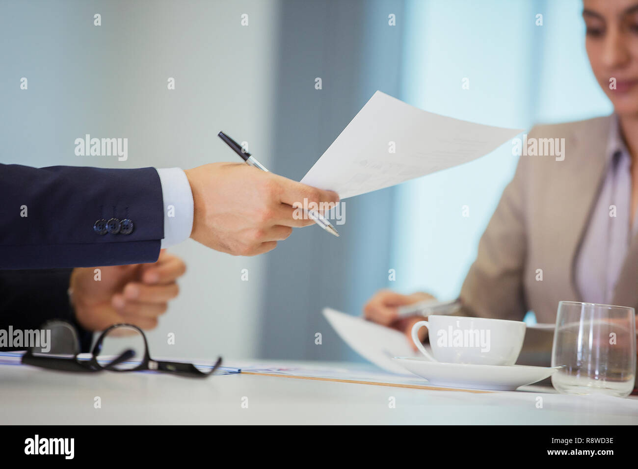 Business people with paperwork in meeting Stock Photo - Alamy