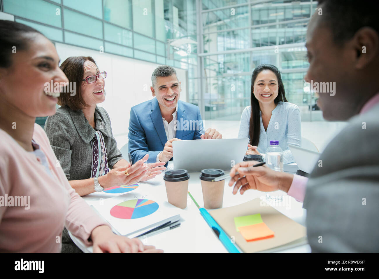 Happy business people laughing in meeting Stock Photo - Alamy