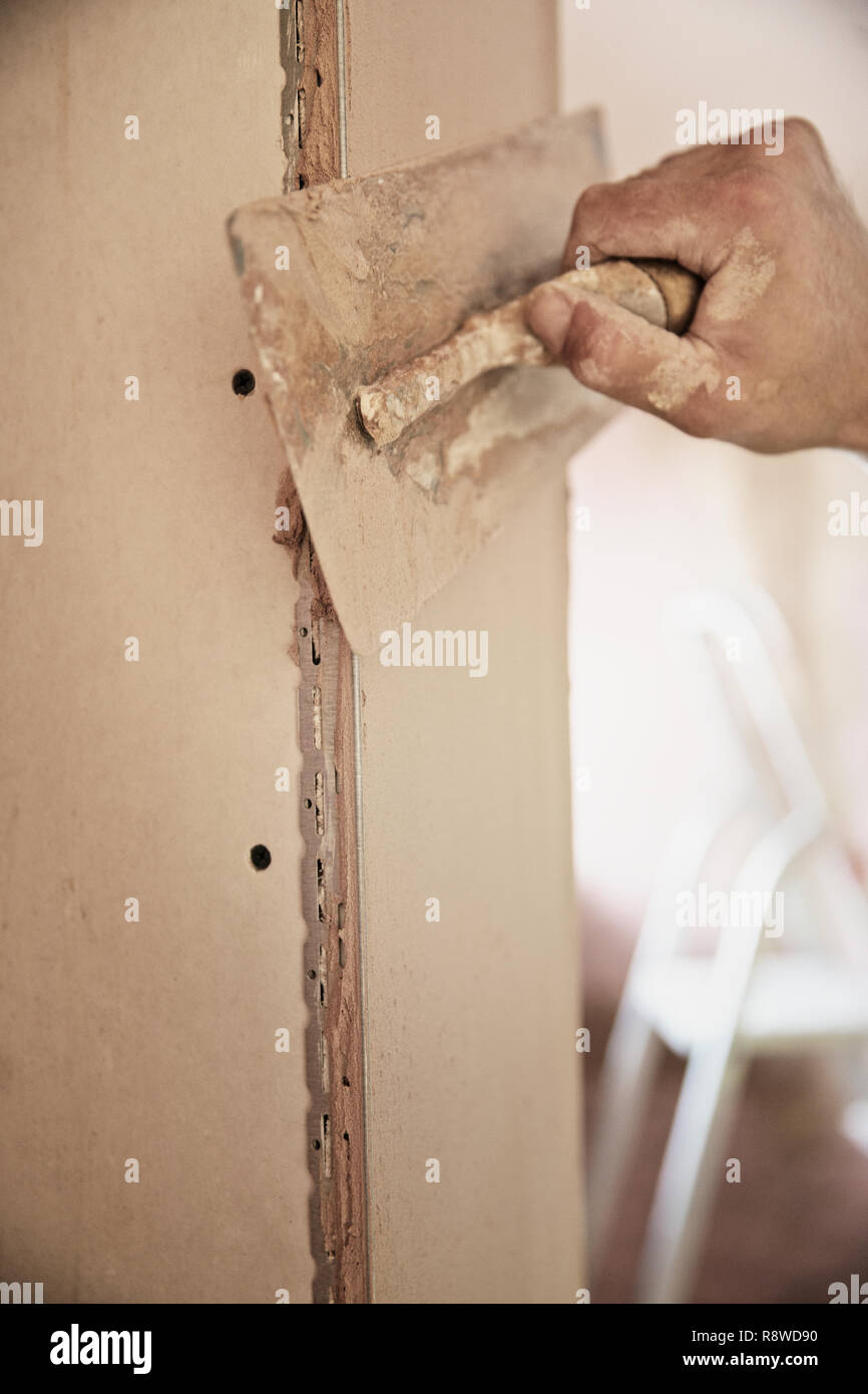 Close up construction worker plastering wall Stock Photo - Alamy