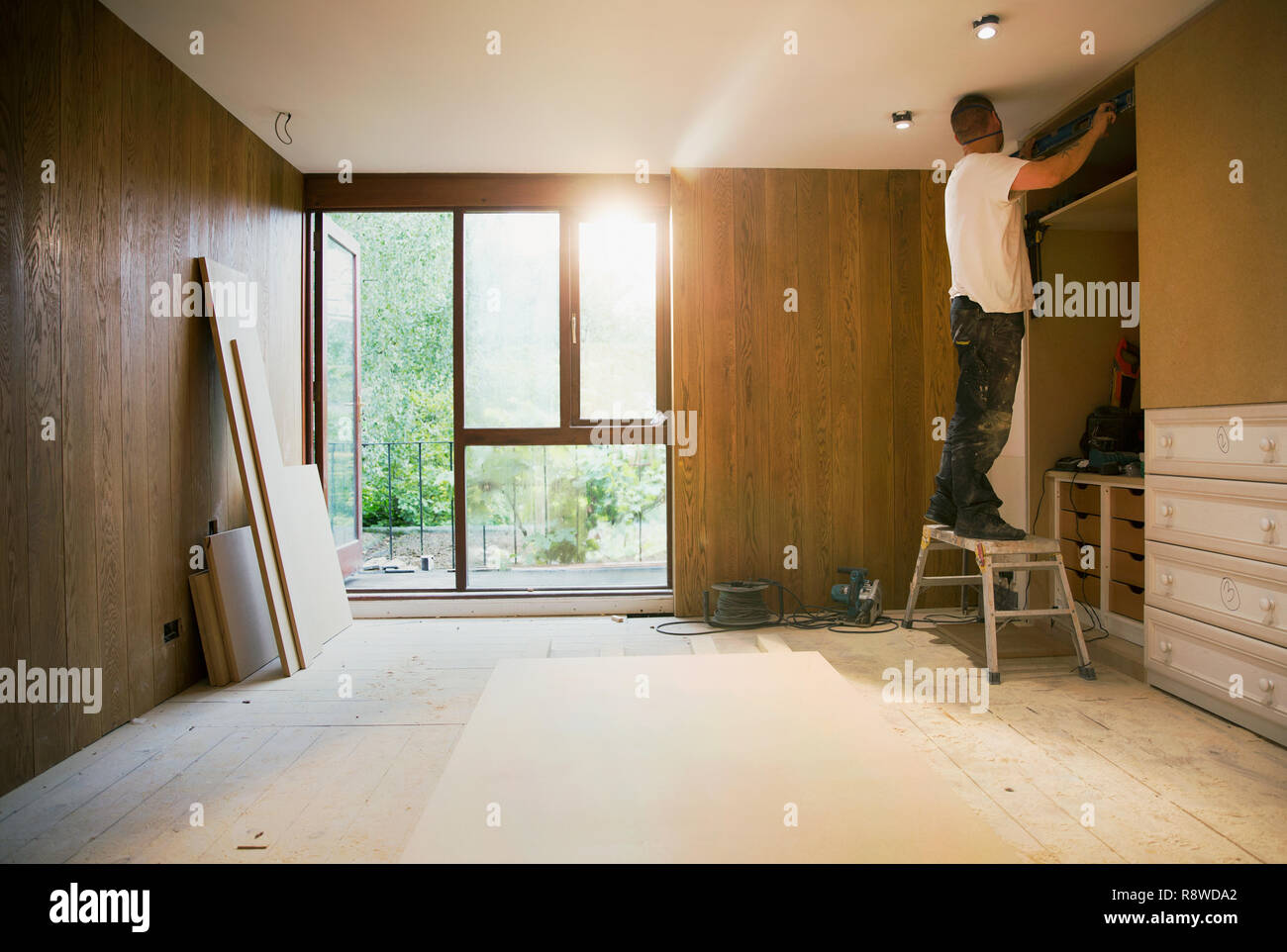 Construction worker working in house Stock Photo - Alamy