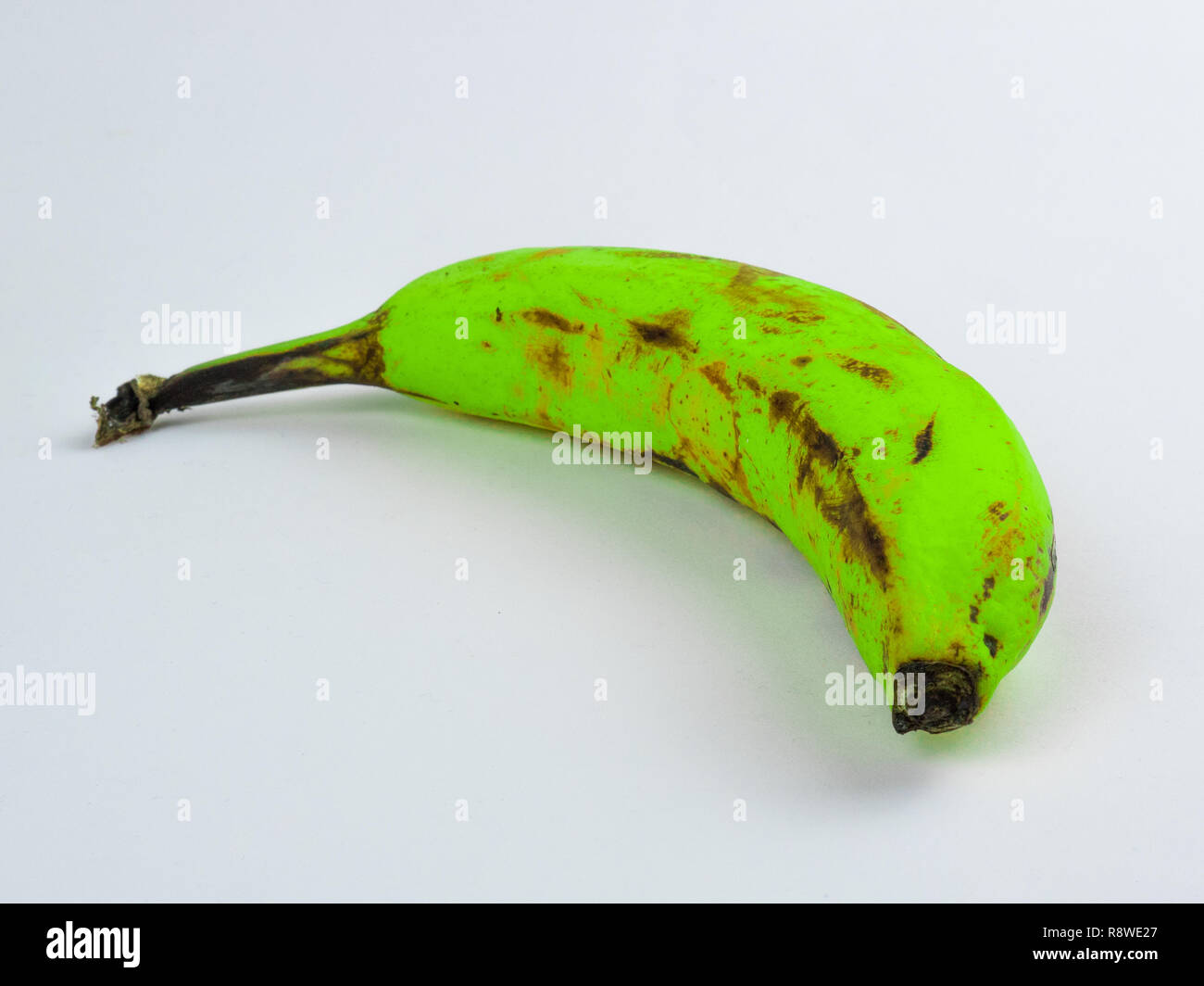 Green neon colored banana on white background Stock Photo - Alamy