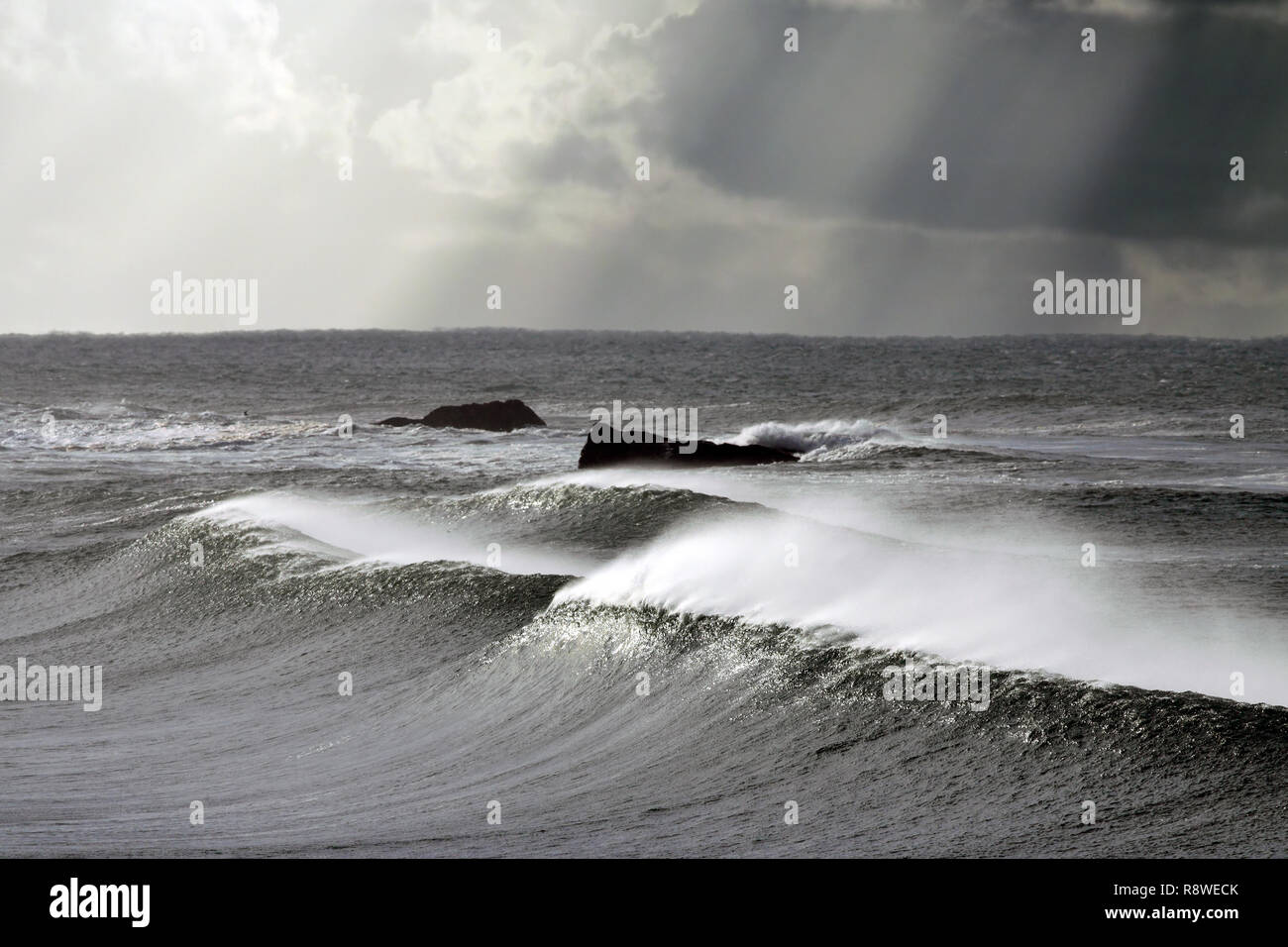Stormy big wave just before sunset with sunbeams (enhanced sky Stock ...