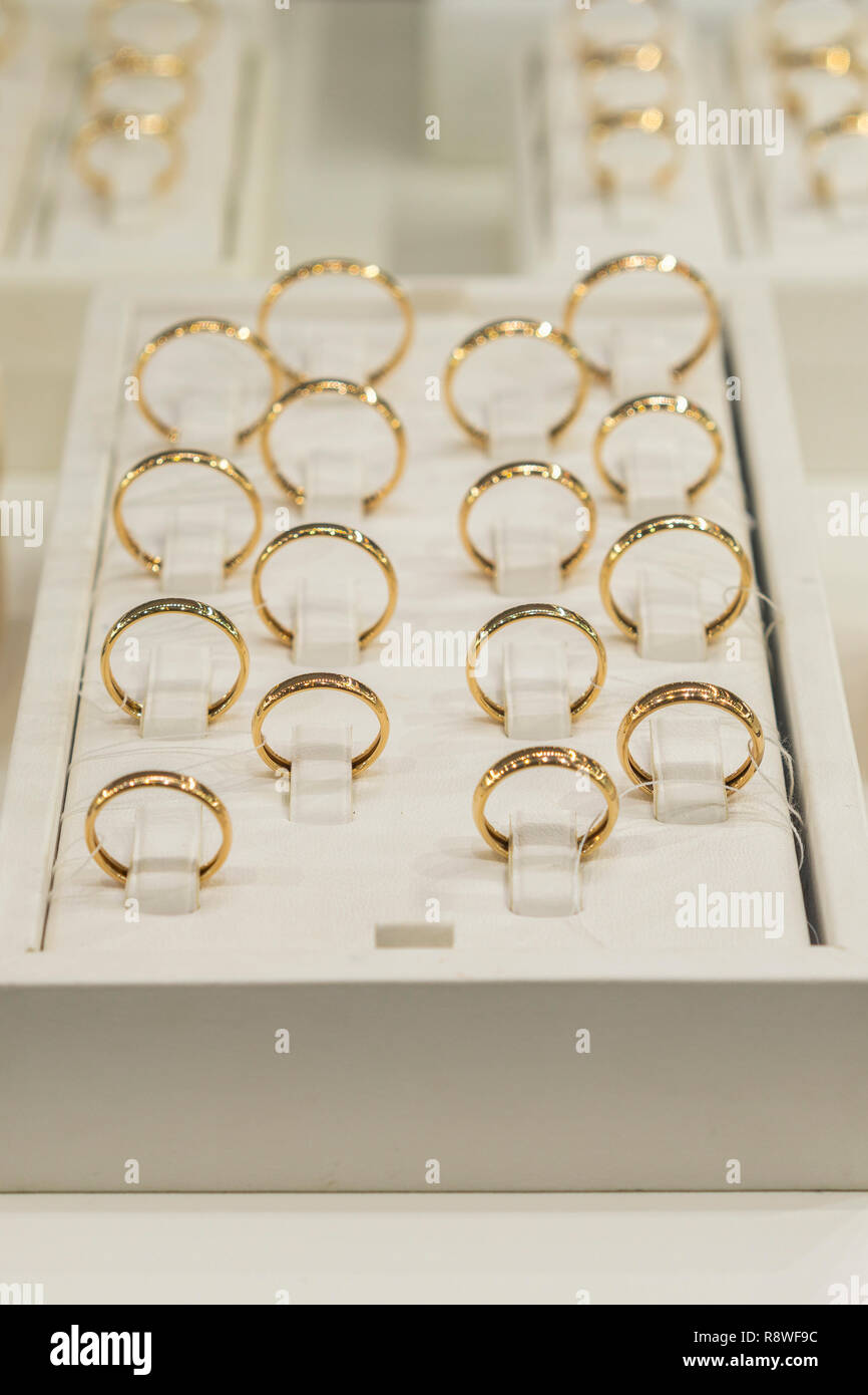golden rings store. Wedding gold rings on the showcase. Wedding ring ...