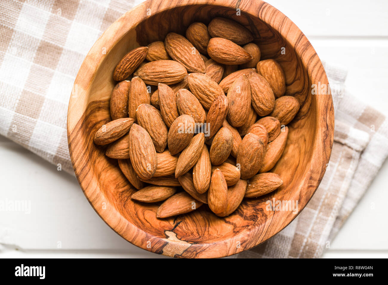 Dried almond nuts in bowl. Top view. Unpeeled almonds Stock Photo - Alamy