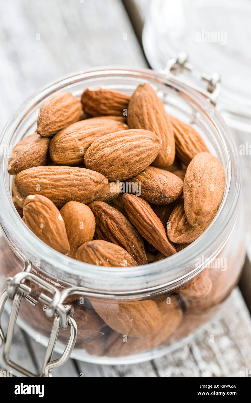 Dried almond nuts in jar. Unpeeled almonds Stock Photo - Alamy