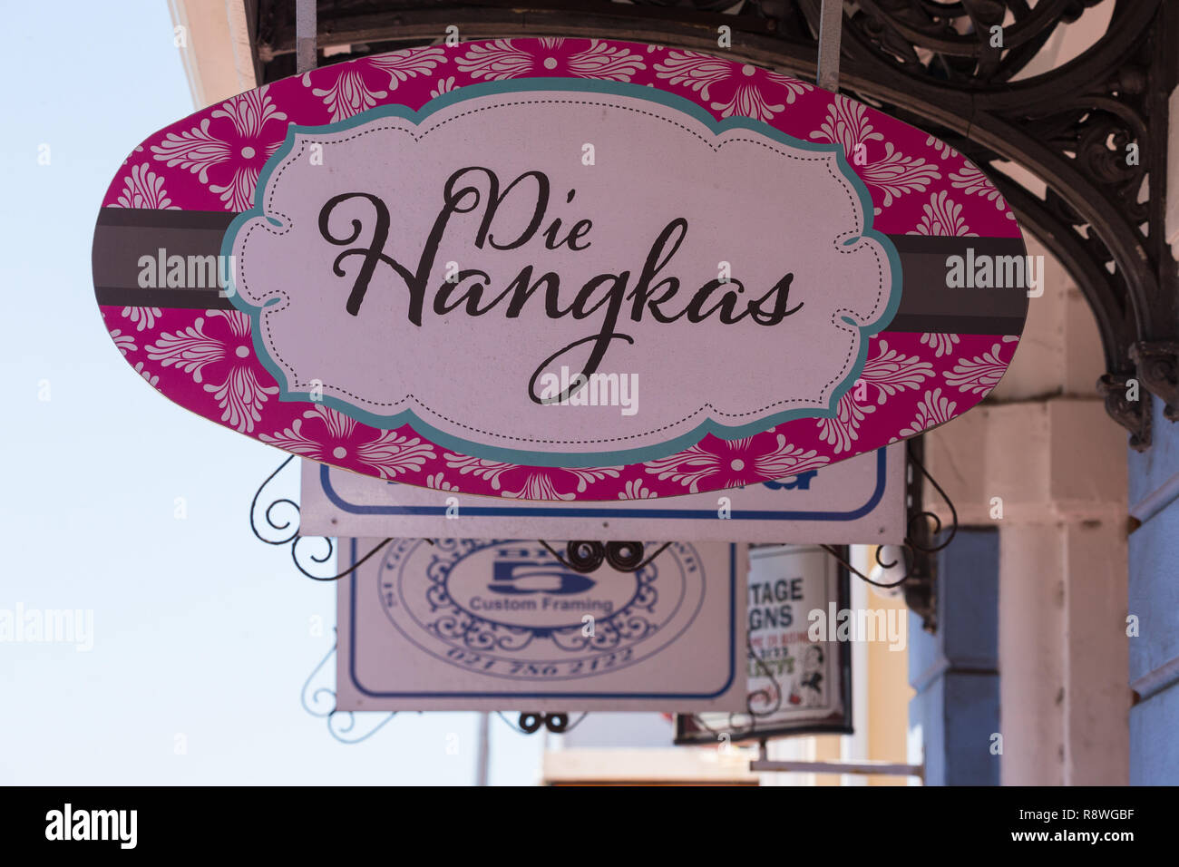 shop signs hanging outside shops on the main road of Simonstown, Cape ...