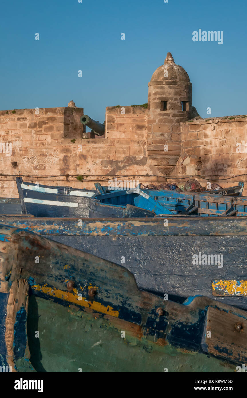 Traditional painted blue wooden fishing boats fill the harbor below the ...