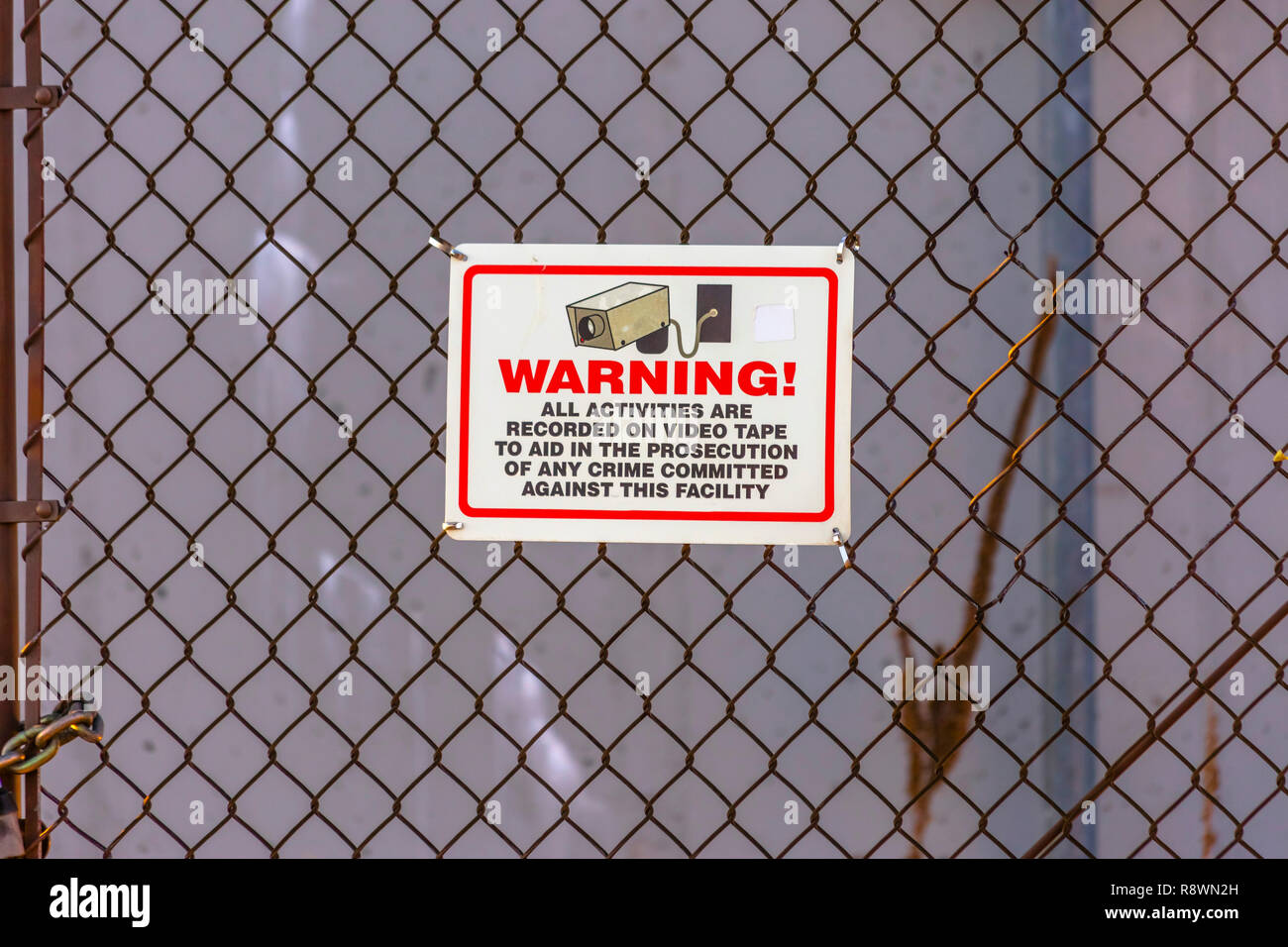 Warning security camera sign on chain link fence Stock Photo - Alamy