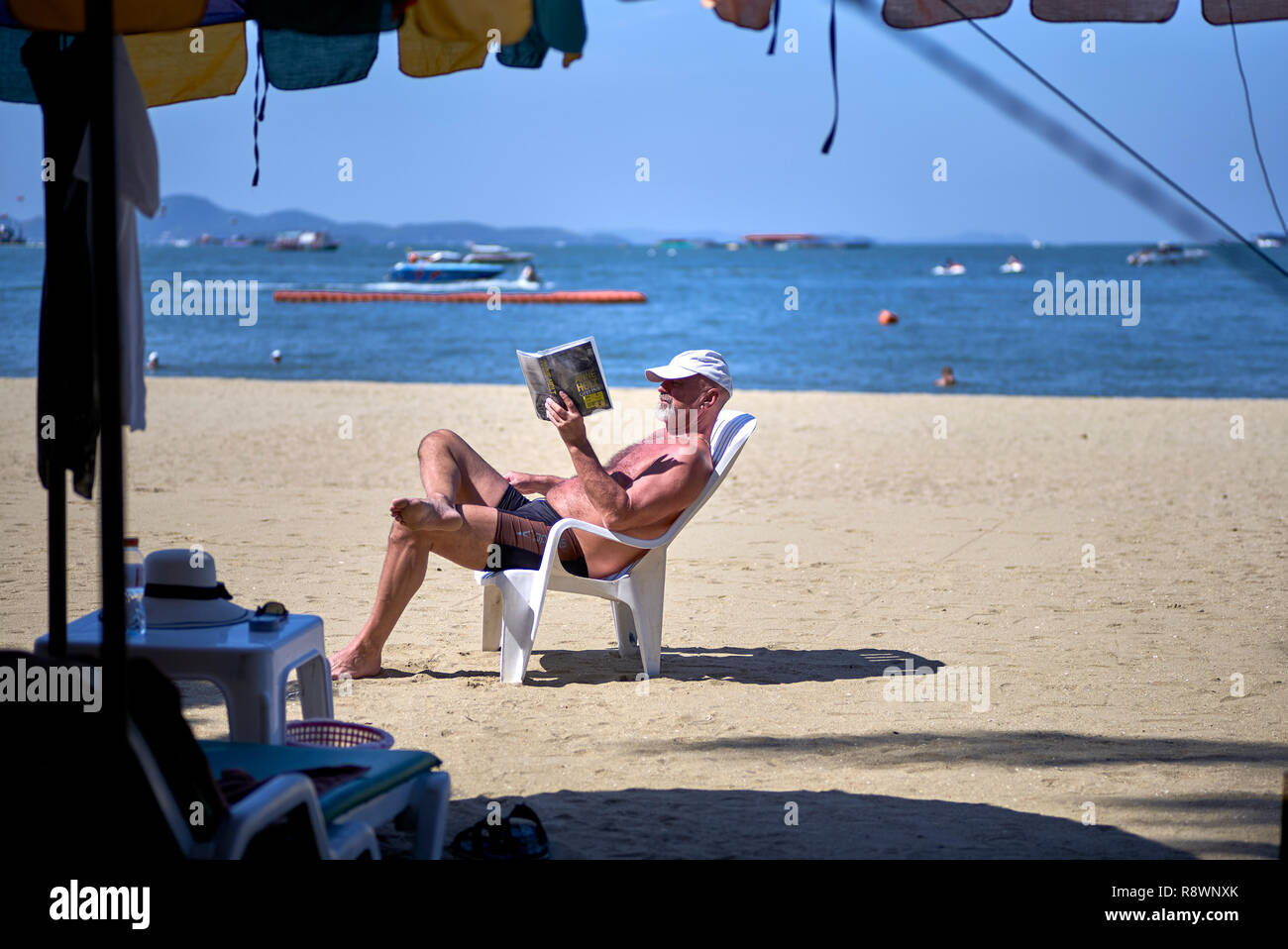 Reading on the beach chair hi-res stock photography and images - Alamy