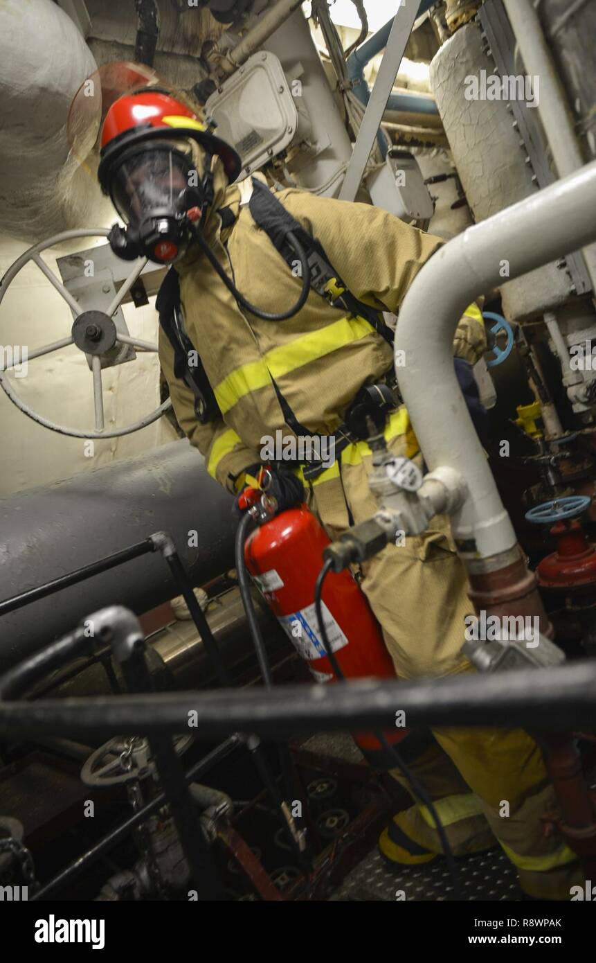 ATLANTIC OCEAN (March 10, 2017) – Fireman Jake Denault investigates the ...