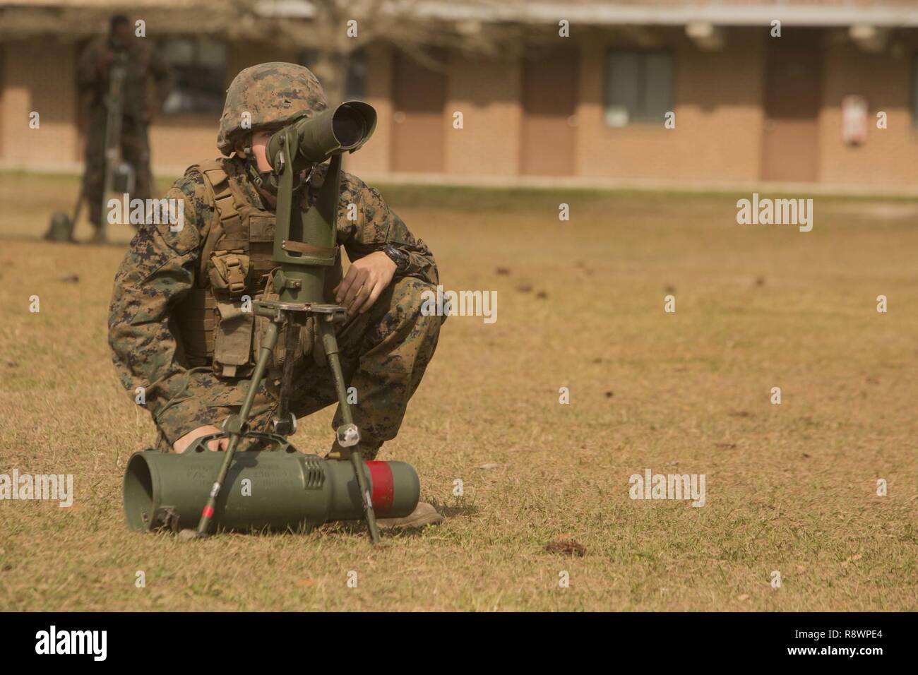 A Marine looks through a collimator, the primary aiming point for the ...