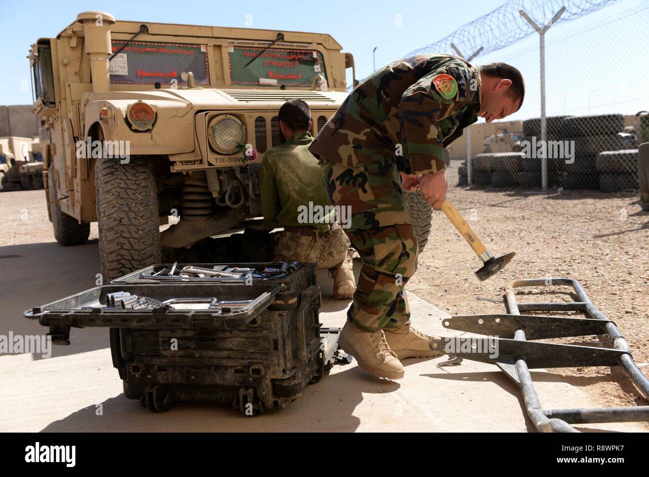 Afghan National Army 215th Corps mechanics work to repair the bumper of ...