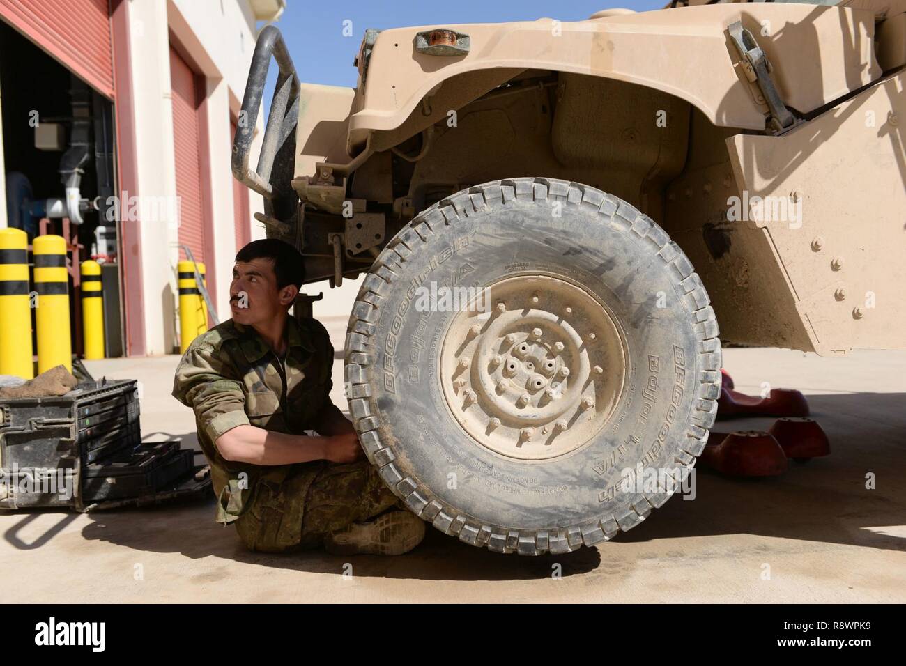An Afghan National Army 215th Corps mechanic works on a Humvee in ...