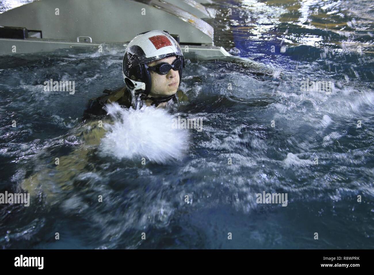 U. S. Marine, 1st Lt. Arthur H. Sakamoto, escapes through an exit of an ...