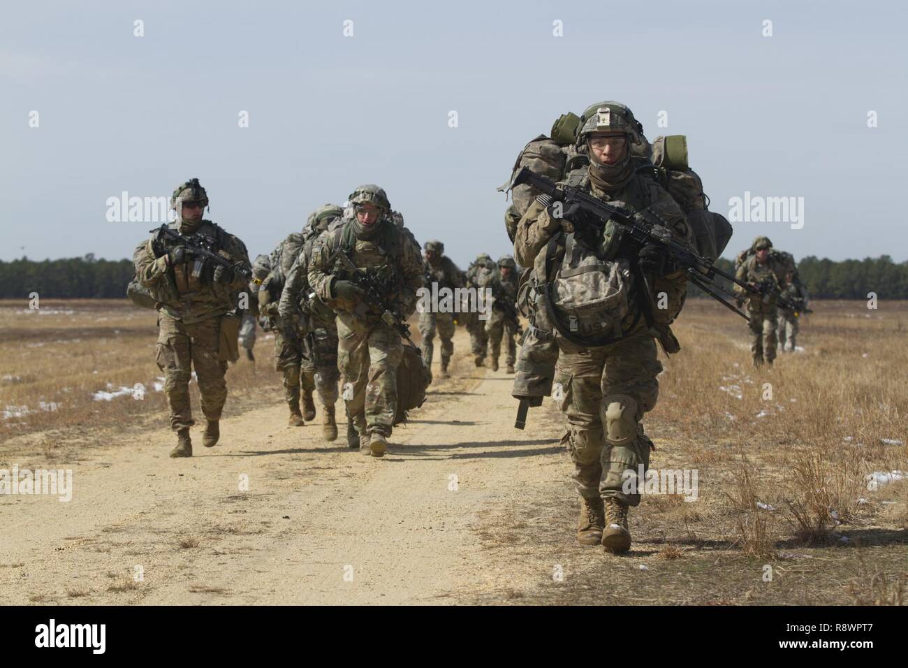 Soldiers assigned to 101st Airborne Division (Air Assault) move towards ...