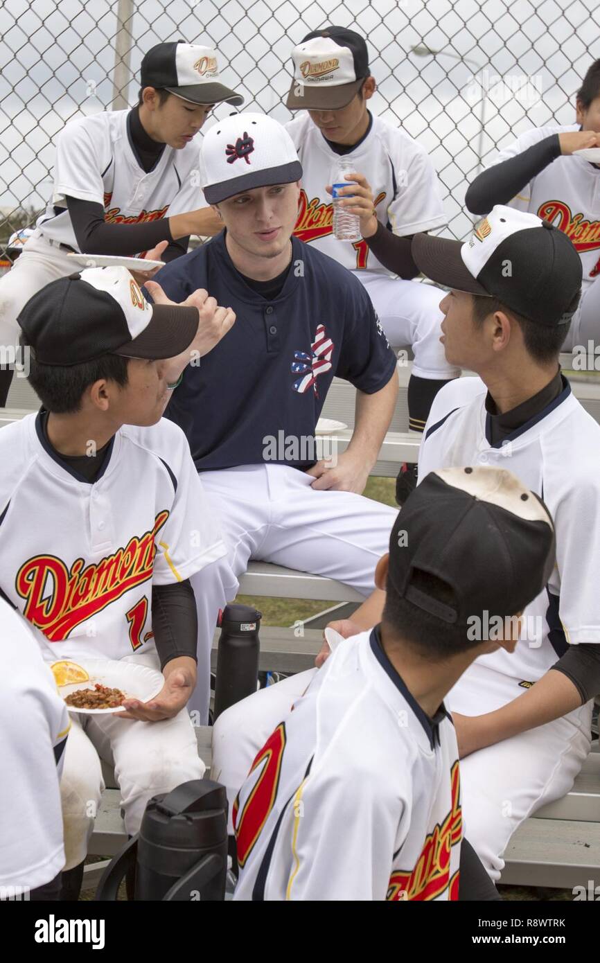 The Okiboys and Okinawa Diamond baseball players talk together March 18 ...