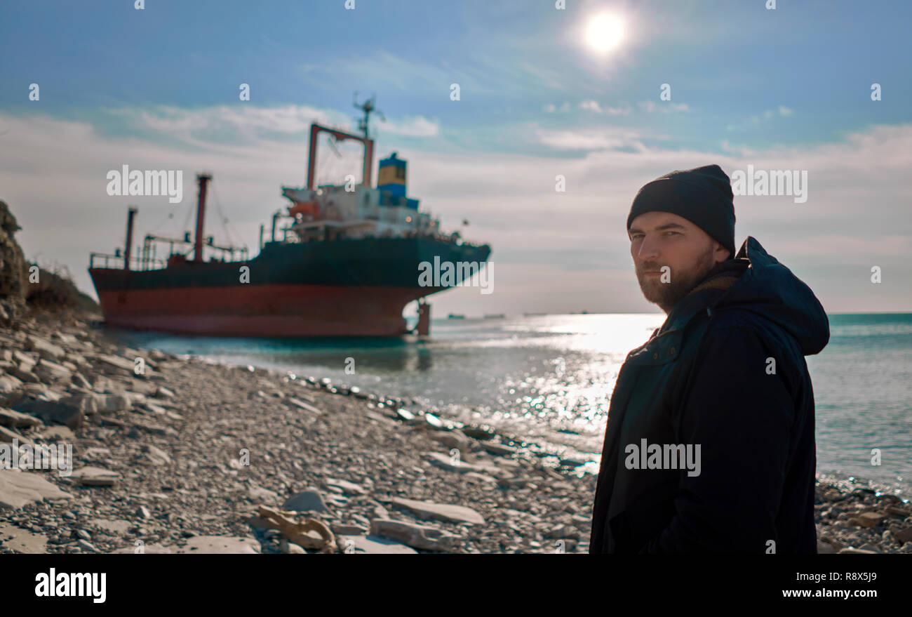 man looking at a cargo ship Stock Photo - Alamy
