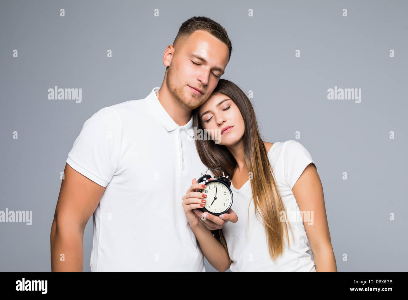 Young couple holding alarm clock hi-res stock photography and images ...