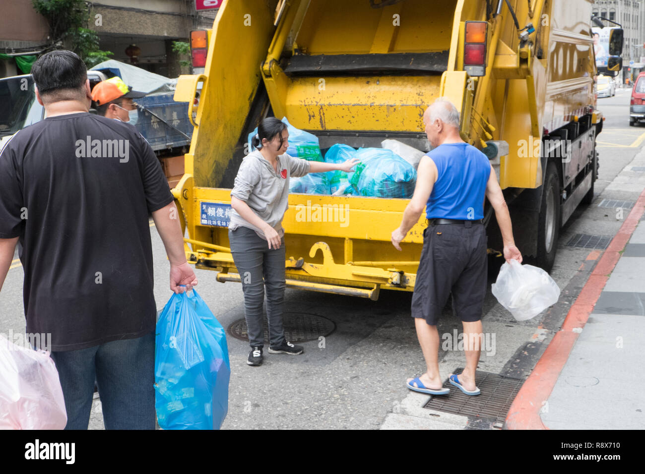Locals,putting,waste,garbage,into,municipal,waste,collection,truck,on ...