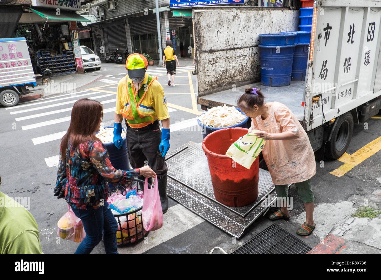 Locals,putting,waste,garbage,into,municipal,waste,collection,truck,on ...