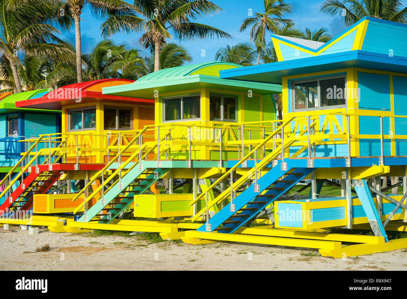 Colorful scenic morning view of brightly painted lifeguard towers with ...