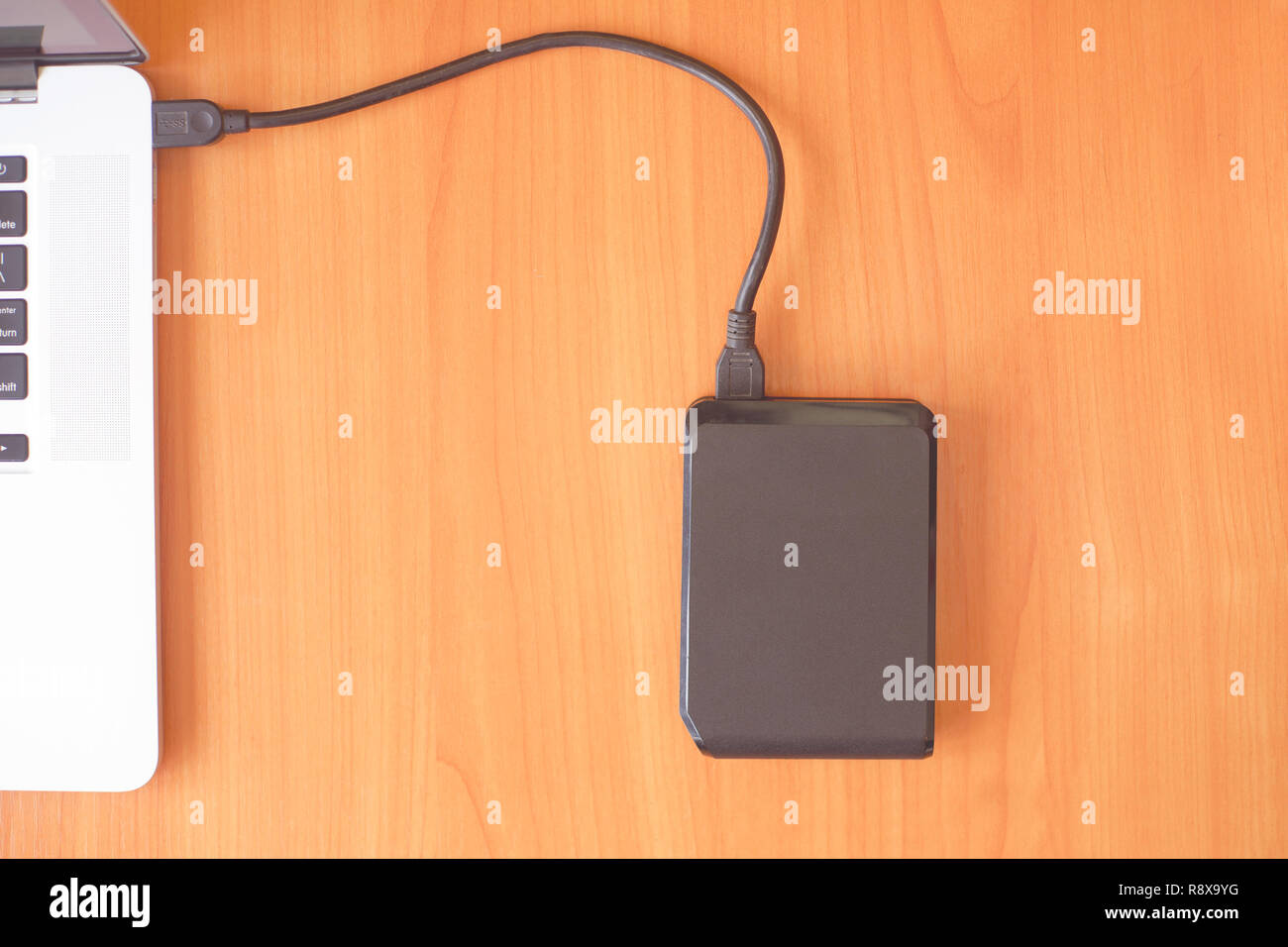 A laptop computer with a portable hard drive for backup your data ...