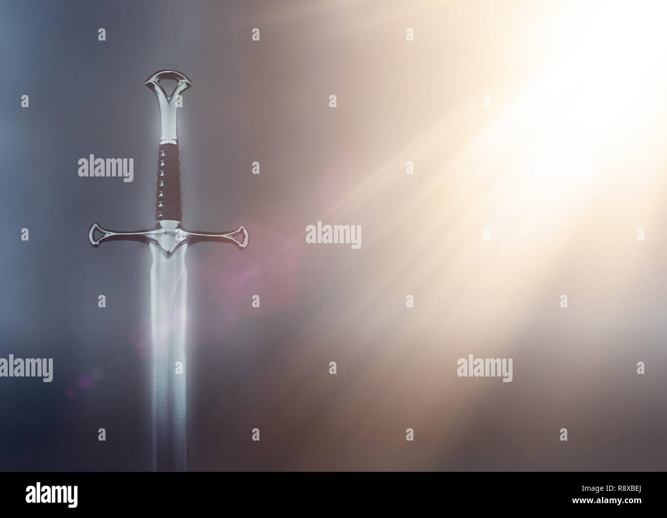 mysterious and magical photo of silver sword over black background with ...