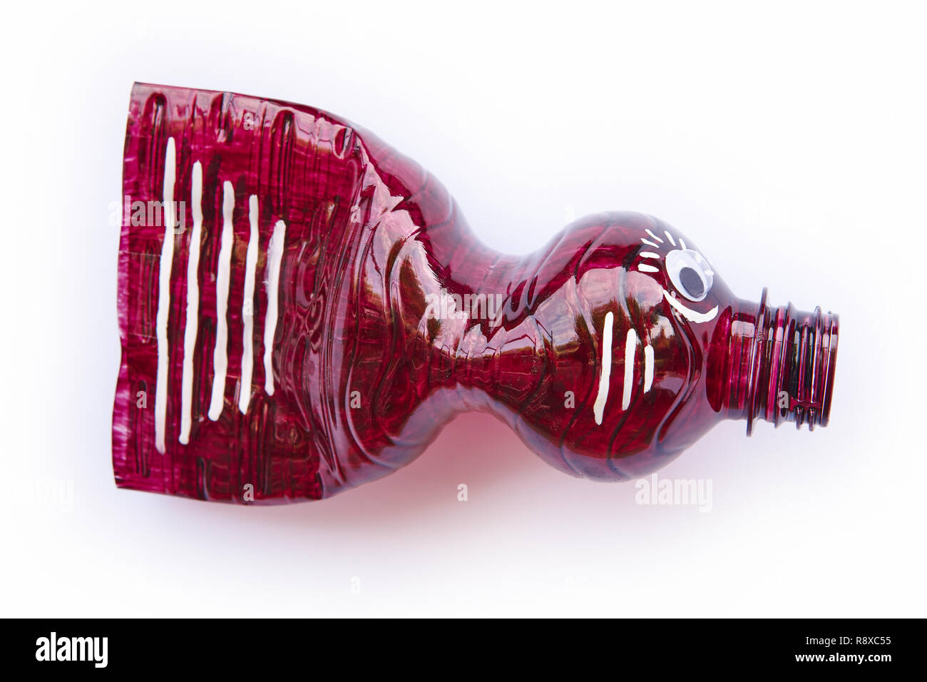 Plastic bottle recycled in a fish figure. Reuse garbage. Isolated Stock ...