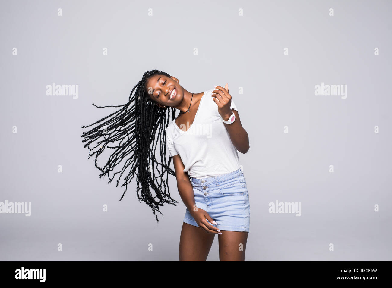 Fascinating african woman with happy face expression playing with her ...