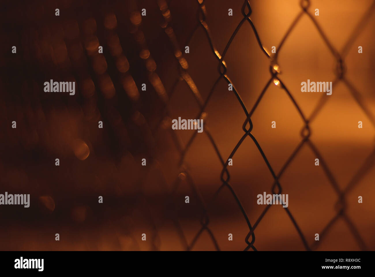 Chain link fence at night Stock Photo - Alamy