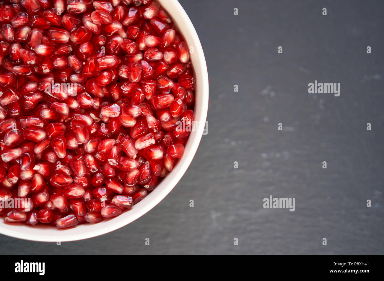 Pomegranate seeds deep red. Pomegranate fruit. Pomegranate on dark ...