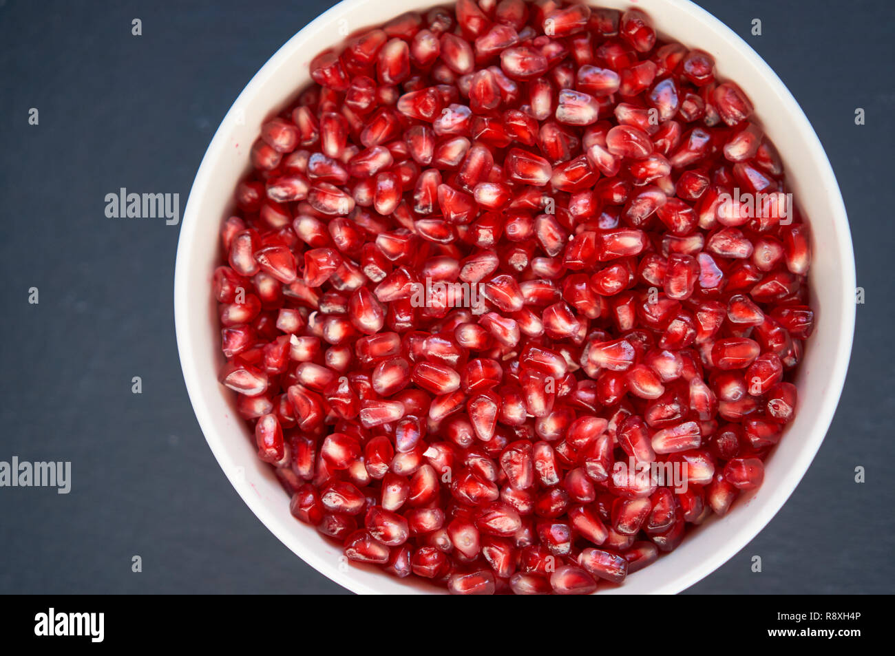 Pomegranate seeds deep red. Pomegranate fruit. Pomegranate on dark ...