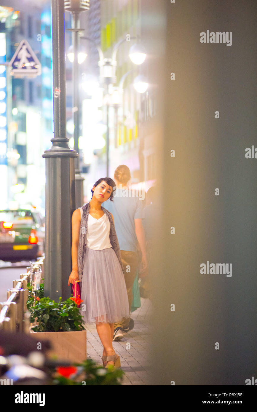 Asian female model poses for pictures in the cityscape Stock Photo - Alamy
