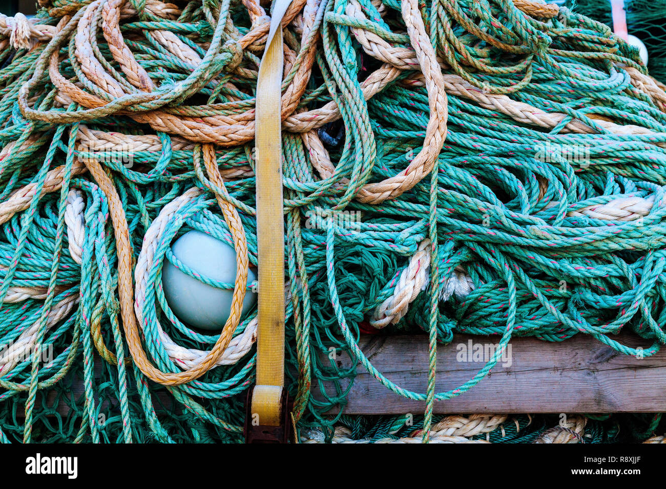 Large messy bundle of green ropes laying on the quay. Port of Bergen ...