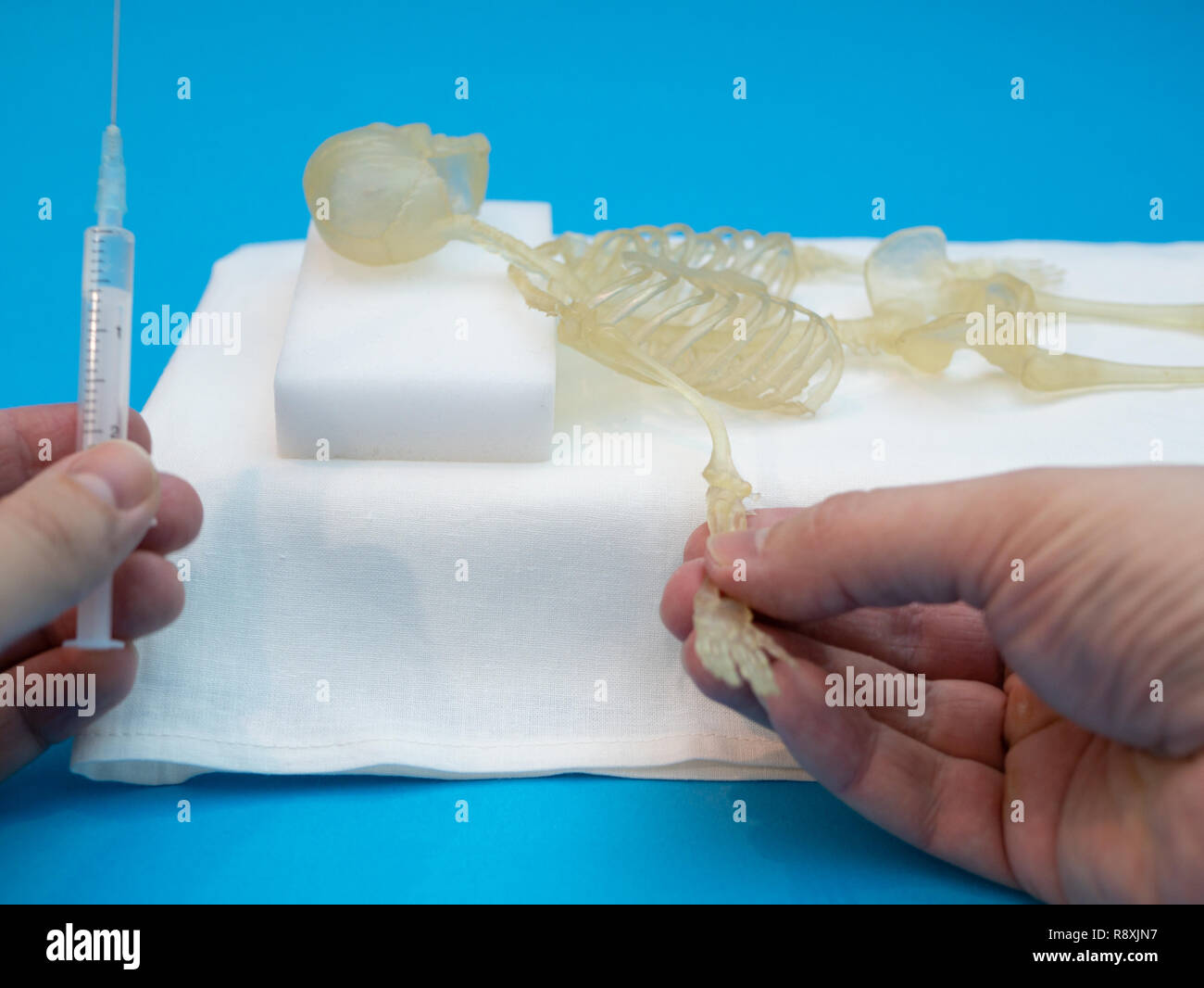 doctor with syringe checking pulse on patient arm. maybe too late to ...