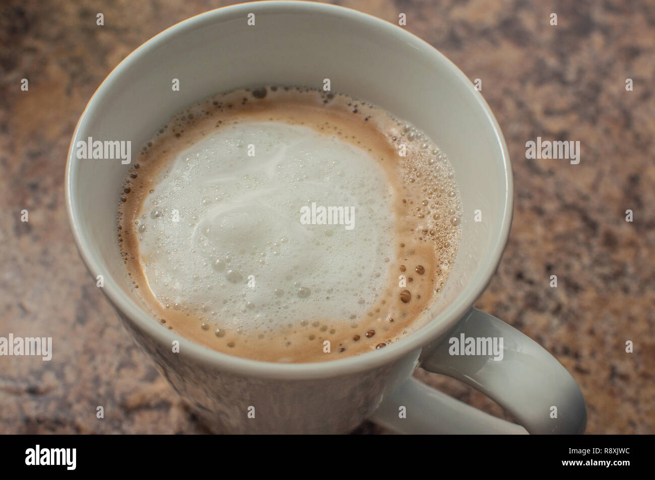 Foam next to espresso or already made latte Stock Photo - Alamy