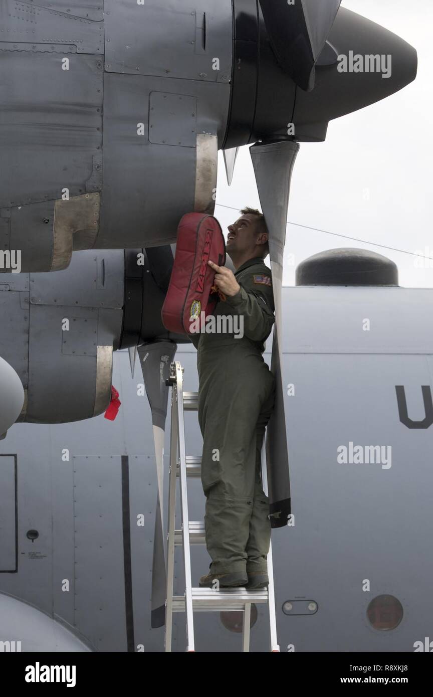 An Airman with the 374th Operations Group does a post flight inspection ...