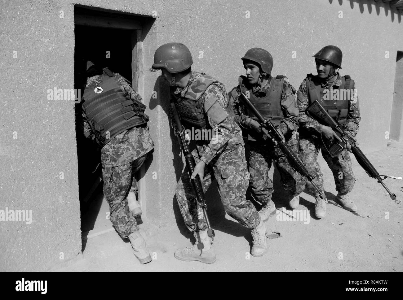 Afgan National Army soldiers run into a building during clearing drills ...