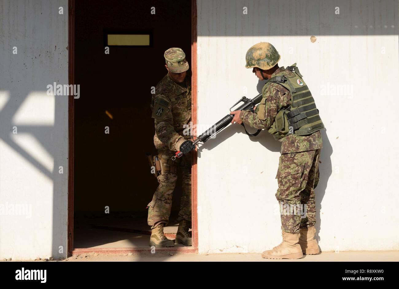 An adviser from NATO Resolute Support unit, Task Force Forge, shows an ...