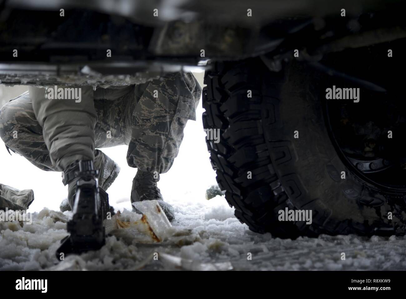 An Airmen assigned to the 105th Airlift Wing places a jack underneath a ...
