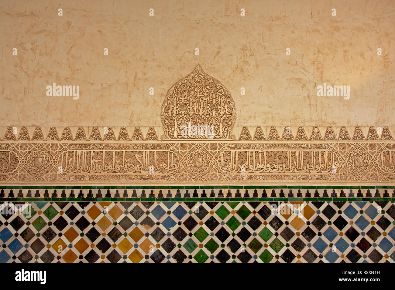 Moorish wall decorations with stone carvings and colorful tiles in ...