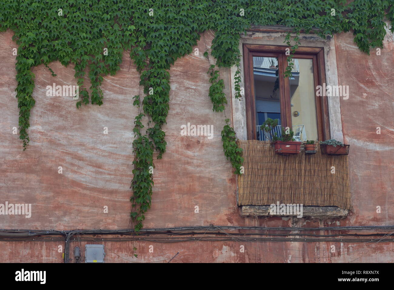 Exterior wall of vintage Mediterranean apartment building with wooden ...
