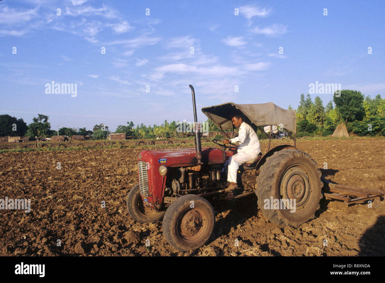 Indian farmer ploughing field tractor hi-res stock photography and ...
