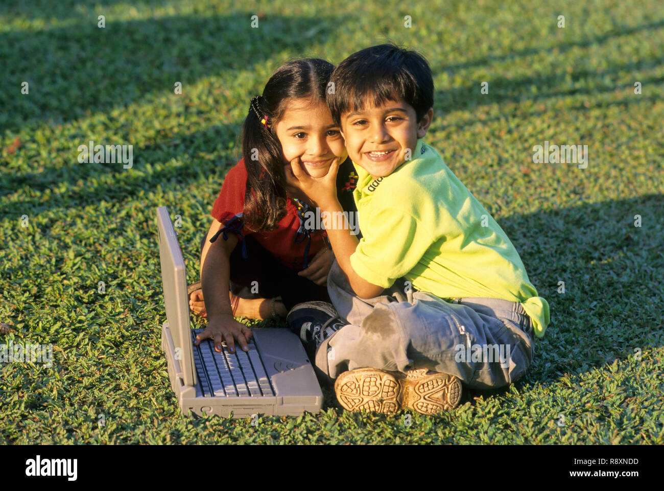 Brother and sister playing on computer MR#273 Stock Photo - Alamy