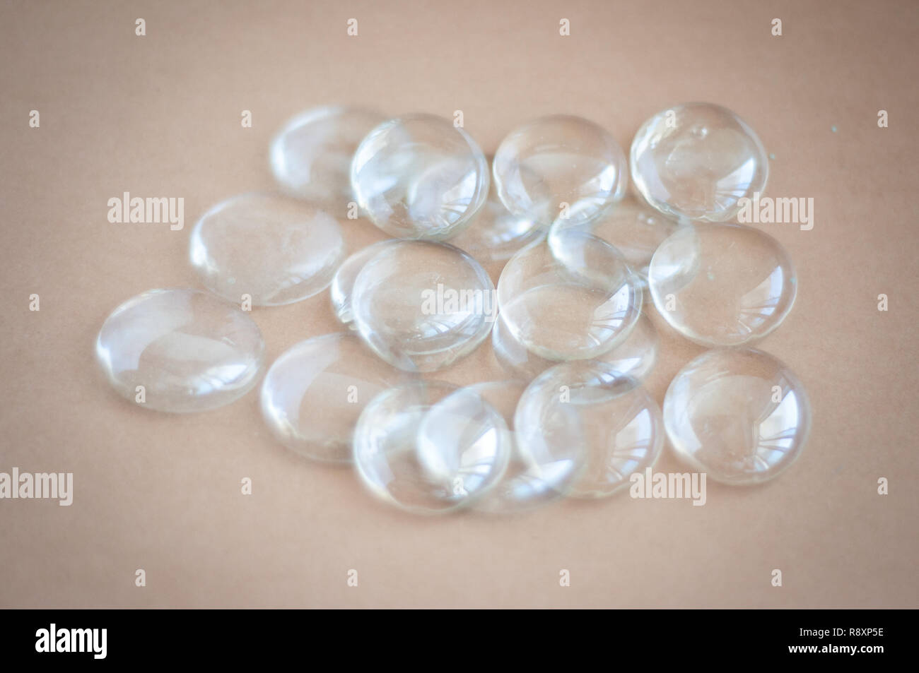 Clear marbles with light reflections on a brown background Stock Photo ...