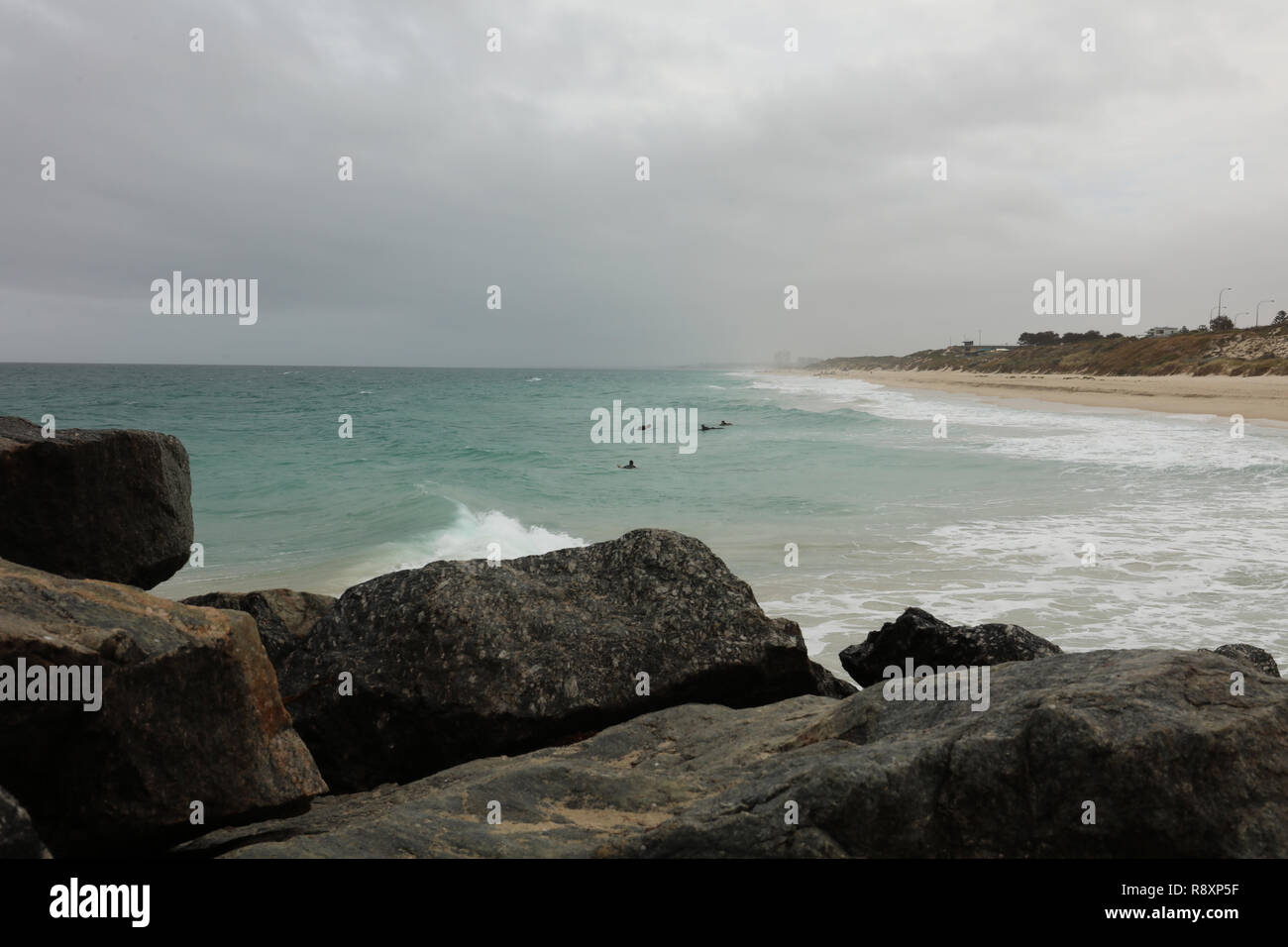 Surfers enjoying and riding the waves of the Indian Ocean on City Beach ...