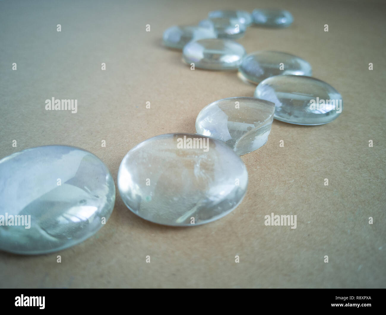 Clear marbles with light reflections on a brown background Stock Photo ...